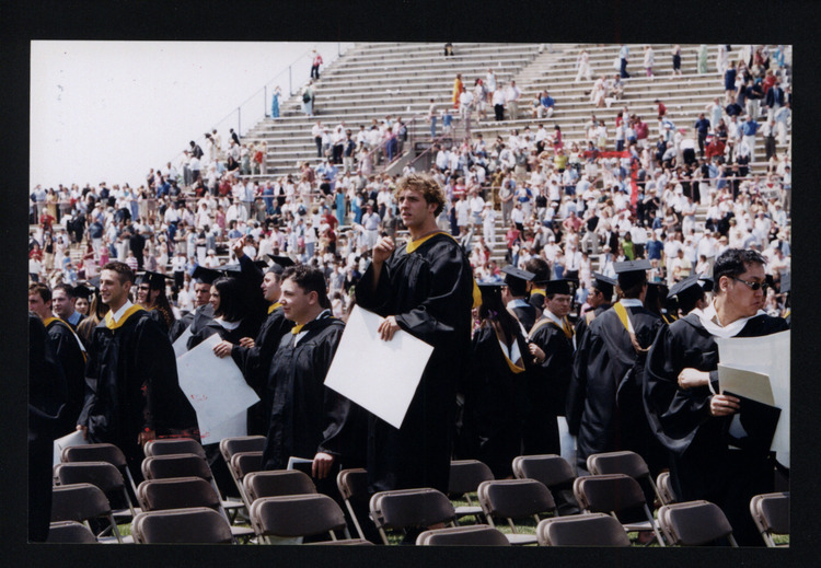 Graduate standing, crowd in background | Lehigh Preserve