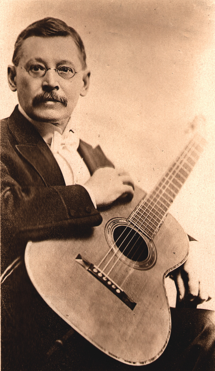 William Foden, concert guitarist and instructor, holding a guitar ...