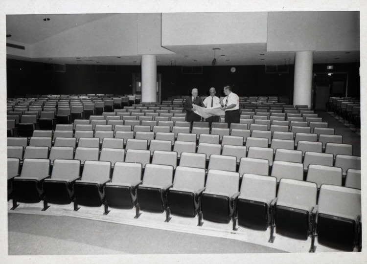 John Karakash and two other men looking at plans in Packard Auditorium ...