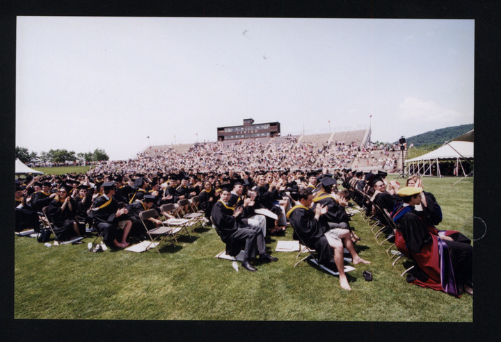 Graduates seated in chairs, crowd in background | Lehigh Preserve