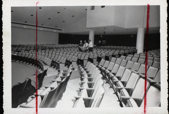 John Karakash and two other men looking at plans in Packard Auditorium | Lehigh Preserve