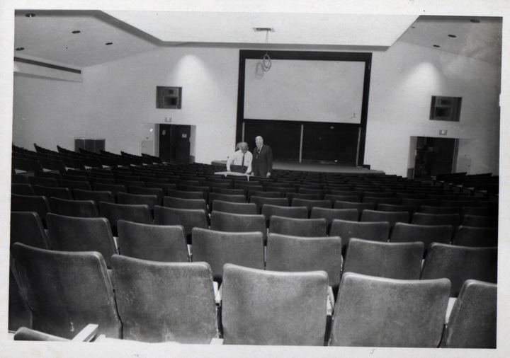 John Karakash and two other men looking at plans in Packard Auditorium | Lehigh Preserve