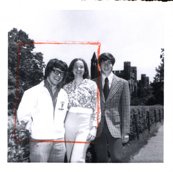 Two male and a female student posed together. Linderman Library is in ...