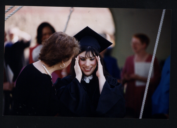 Female graduate holding hands on face smiling, next to female | Lehigh ...