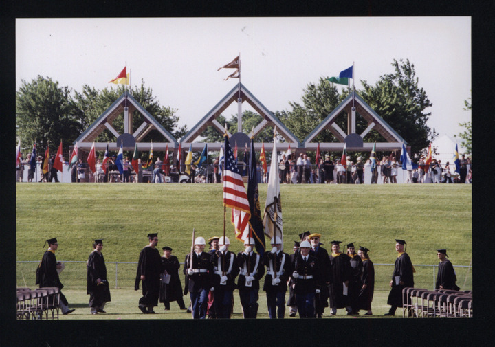 Men in uniform carrying flags - flags in background | Lehigh Preserve
