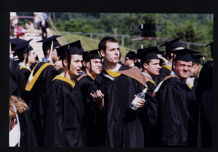 Male graduates standing, one holding water bottle | Lehigh Preserve