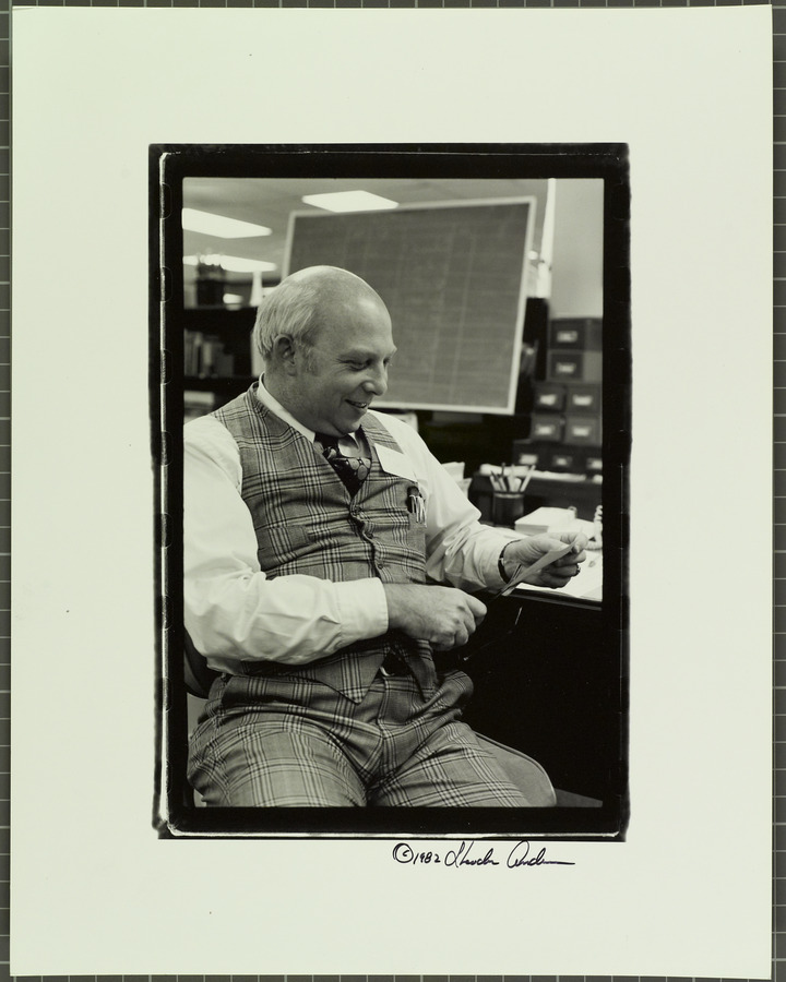 Portrait of Walter Leach, Class of 1957, looking at a check at a Lehigh ...