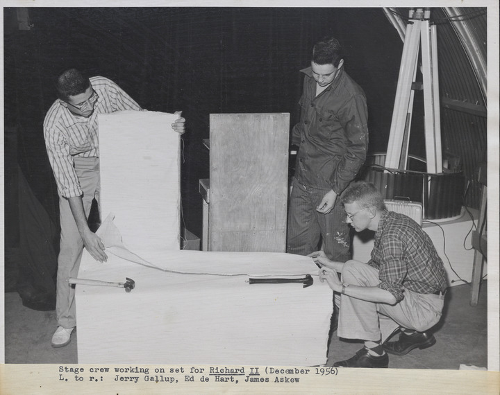 Black and white photo, typewritten caption reads Stage crew working on ...